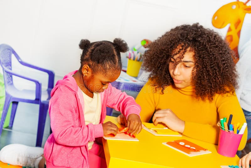 Girl in Nursery School Learning To Button Unbutton Stock Image - Image ...