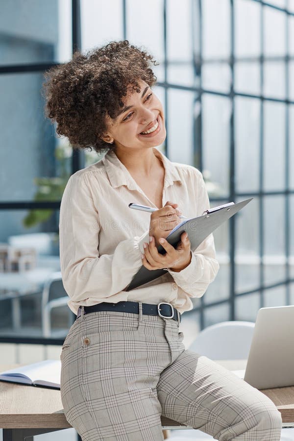 Girl in the Office Smiles Writing Notes Stock Photo - Image of ...