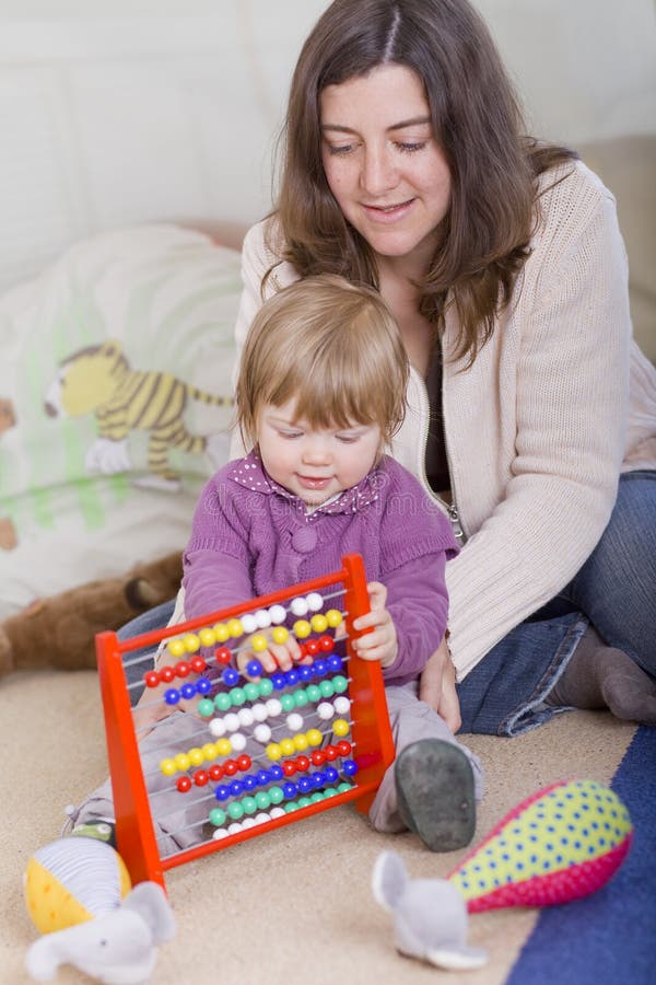 Girl one year old learning stock image. Image of child - 13985021