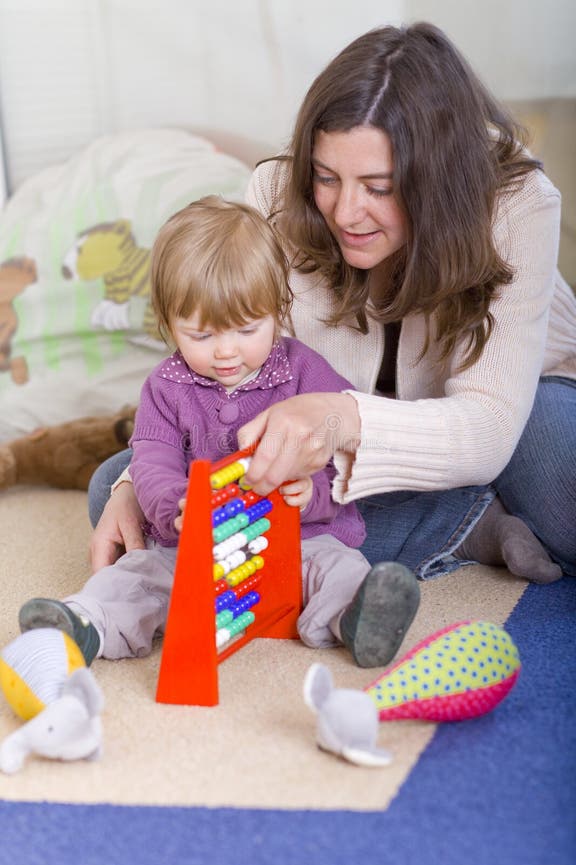Girl one year old learning stock image. Image of child - 13985021