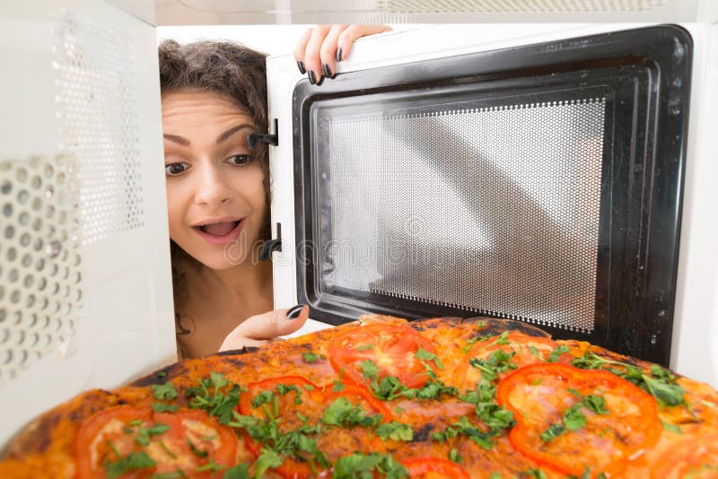 Girl open a microwave stock image. Image of greens, hand - 31074889