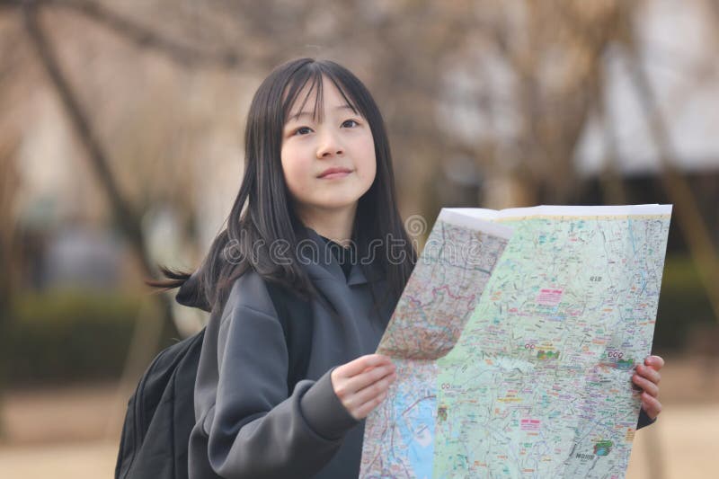 Girl opening a map stock image. Image of study, hobby - 343350981