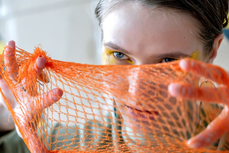 Girl with an Orange Mesh on Her Face. Stock Photo - Image of girl ...