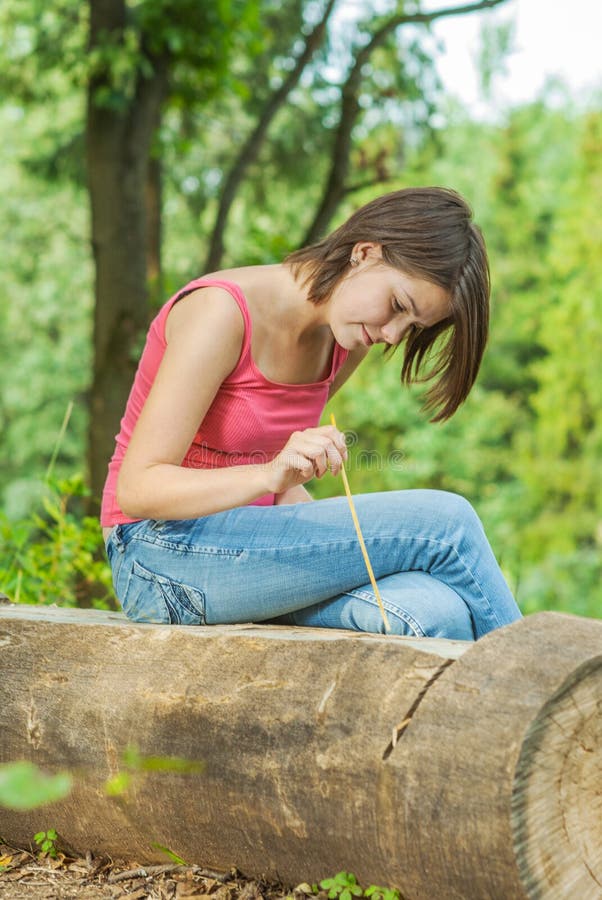 Girl Outdoors in Woods Sitting on Log Stock Photo - Image of looking ...