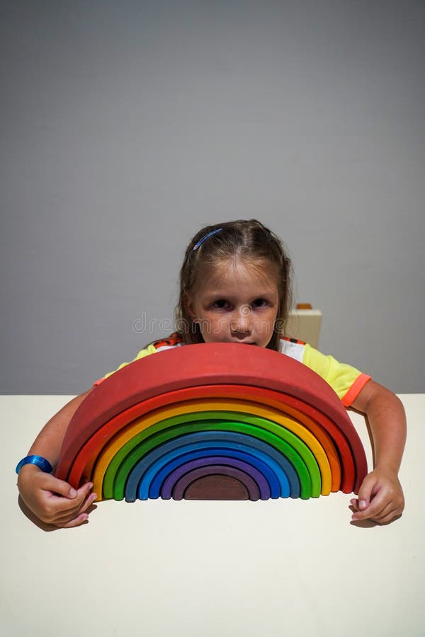 A Girl Peeks Out from Behind a Huge Rainbow Constructor. Mental ...