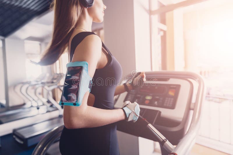 A Girl Performs a God Exercise on a Treadmill. Stock Image - Image of ...