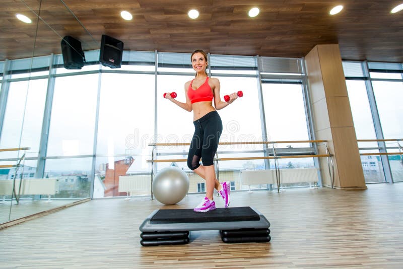 Girl Performs Step Cardio with Dumbbells in a Gym Stock Image - Image ...