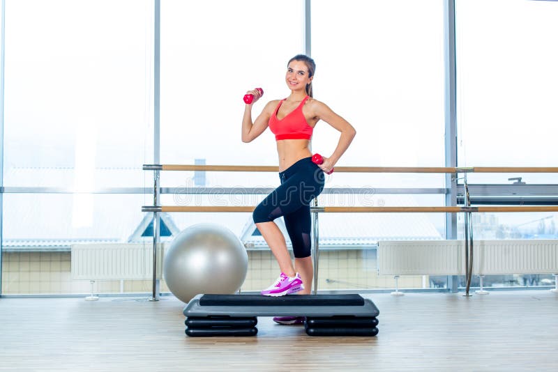 Girl Performs Step Cardio with Dumbbells in a Gym Stock Image - Image ...