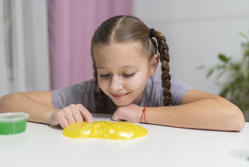 Girl Play with Yellow Slime at Table Fun at Home Stock Image - Image of ...