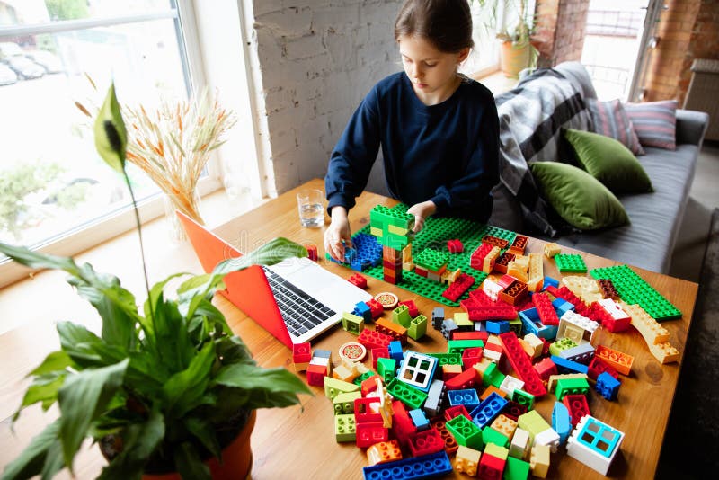 Girl Playing with Constructor at Home, Watching Teacher`s Tutorial on ...