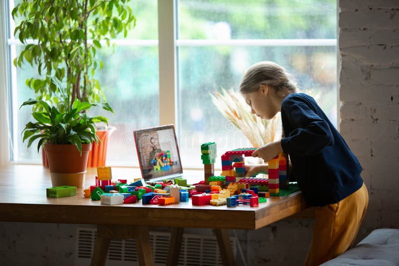 Girl Playing with Constructor at Home, Watching Teacher`s Tutorial on ...