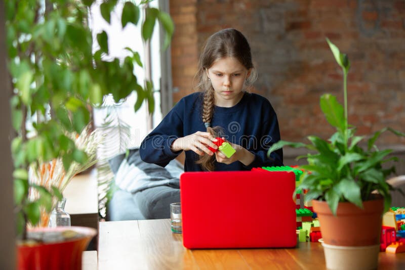 Girl Playing with Constructor at Home, Watching Teacher`s Tutorial on ...