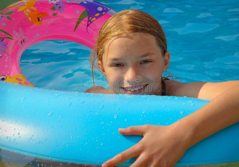 Girl Playing in Paddling Pool Stock Photo - Image of playing, leans ...