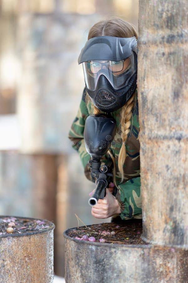 Girl Playing Paintball in Overalls with a Gun. Stock Photo - Image of ...