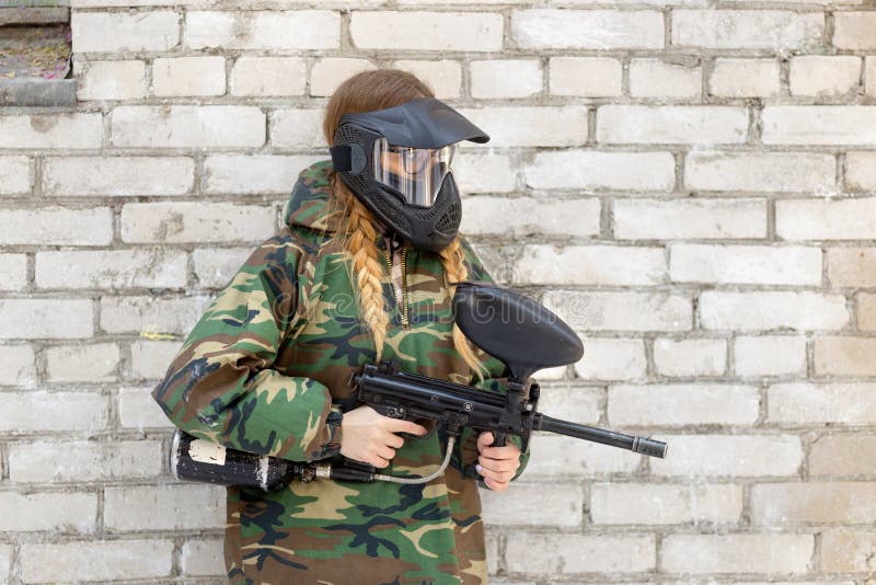 Girl Playing Paintball in Overalls with a Gun. Stock Photo - Image of ...
