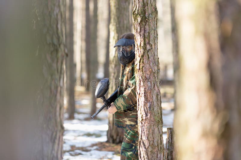 Girl Playing Paintball in Overalls with a Gun. Stock Image - Image of ...