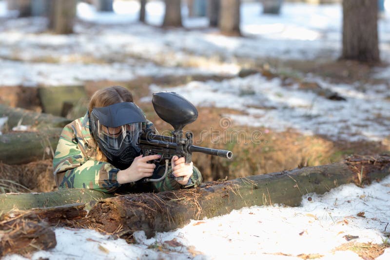 Girl Playing Paintball in Overalls with a Gun. Stock Image - Image of ...