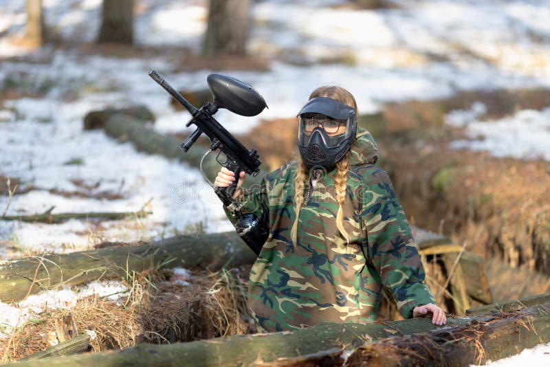 Girl Playing Paintball in Overalls with a Gun. Stock Image - Image of ...