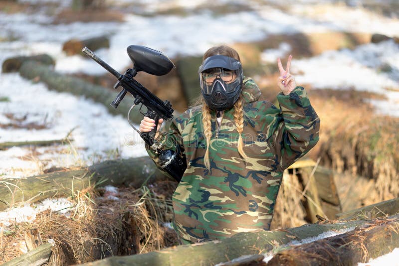 Girl Playing Paintball in Overalls with a Gun. Stock Photo - Image of ...
