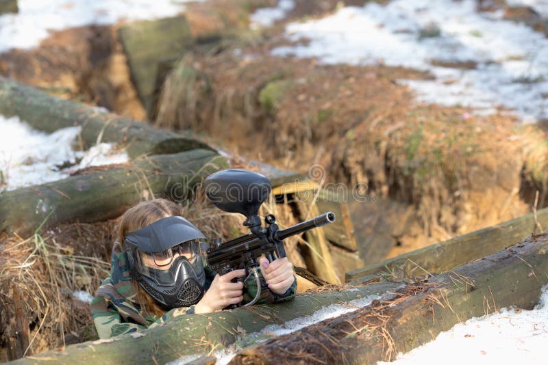 Girl Playing Paintball in Overalls with a Gun. Stock Photo - Image of ...