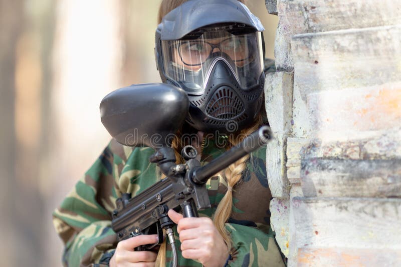 Girl Playing Paintball in Overalls with a Gun. Stock Image - Image of ...