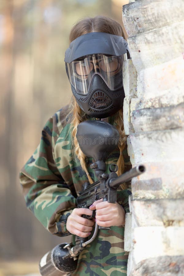 Girl Playing Paintball in Overalls with a Gun. Stock Photo - Image of ...