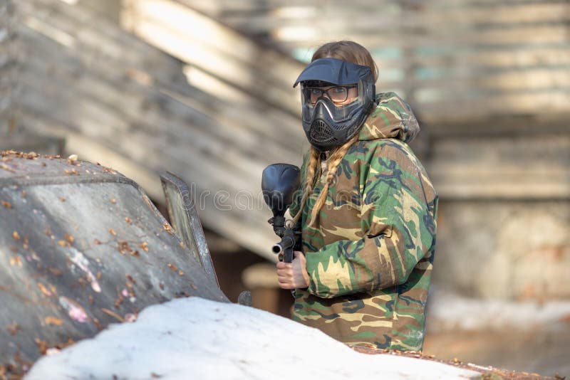 Girl Playing Paintball in Overalls with a Gun. Stock Image - Image of ...