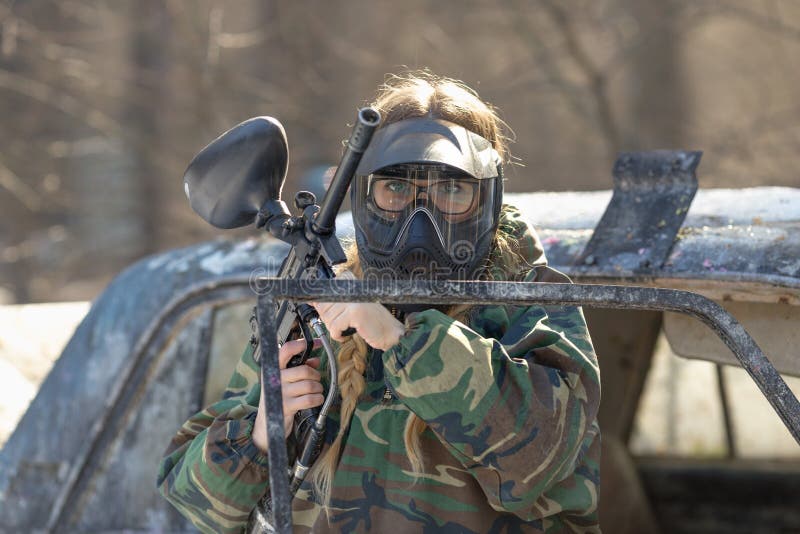 Girl Playing Paintball in Overalls with a Gun. Stock Image - Image of ...