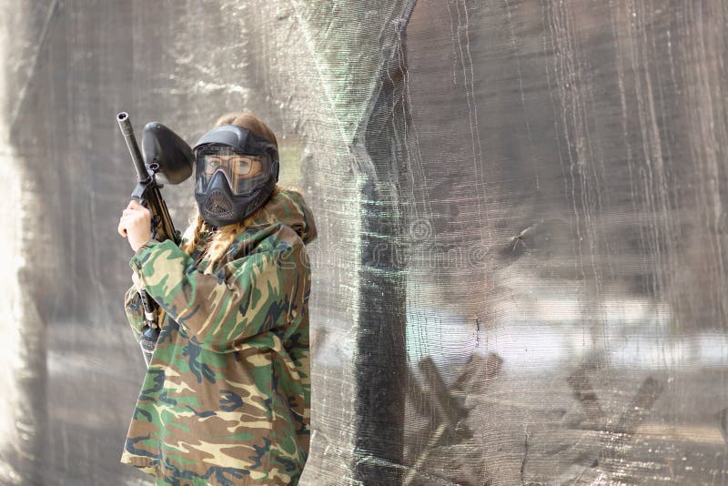 Girl Playing Paintball in Overalls with a Gun. Stock Photo - Image of ...