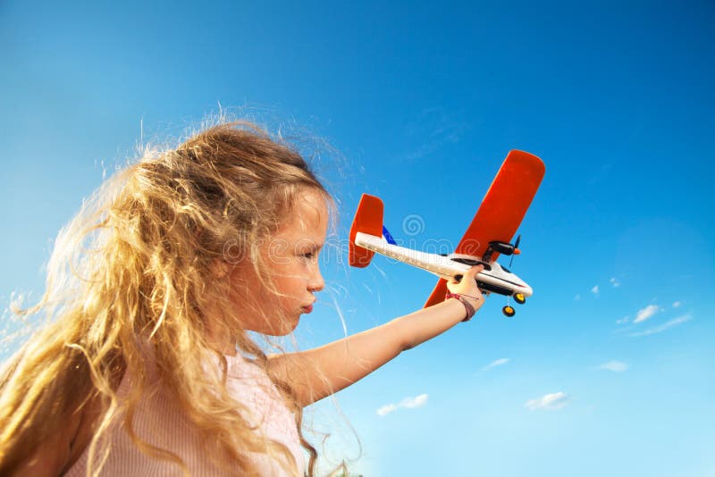 Girl playing with plane stock image. Image of child - 184866289