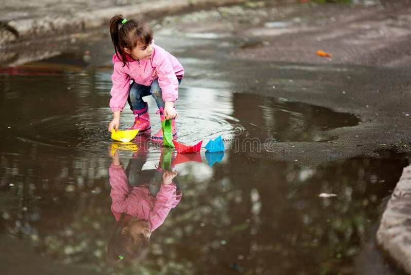 Funny 2 Years Old Baby Girl Playing in Puddle. Stock Image - Image of ...