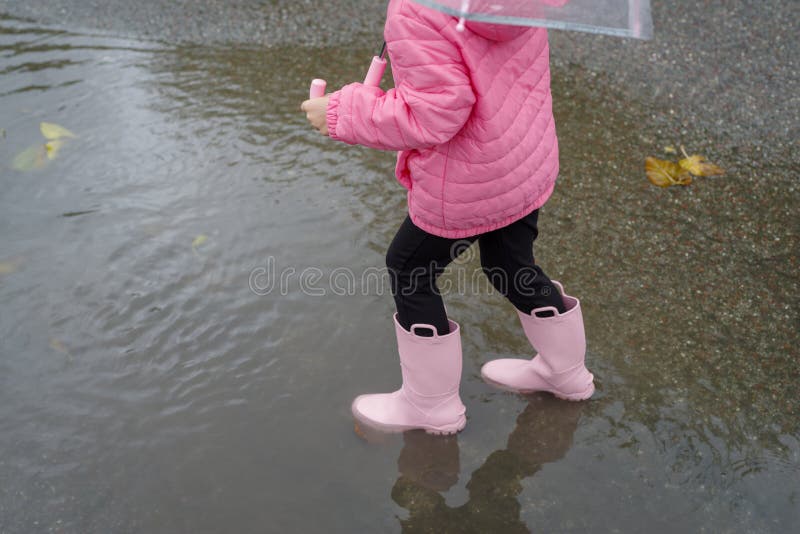 Girl playing in puddle stock photo. Image of girl, crown - 371817296
