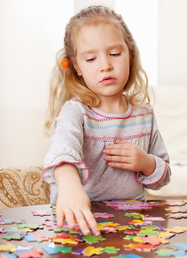Girl playing puzzle stock photo. Image of cute, childhood - 23401980