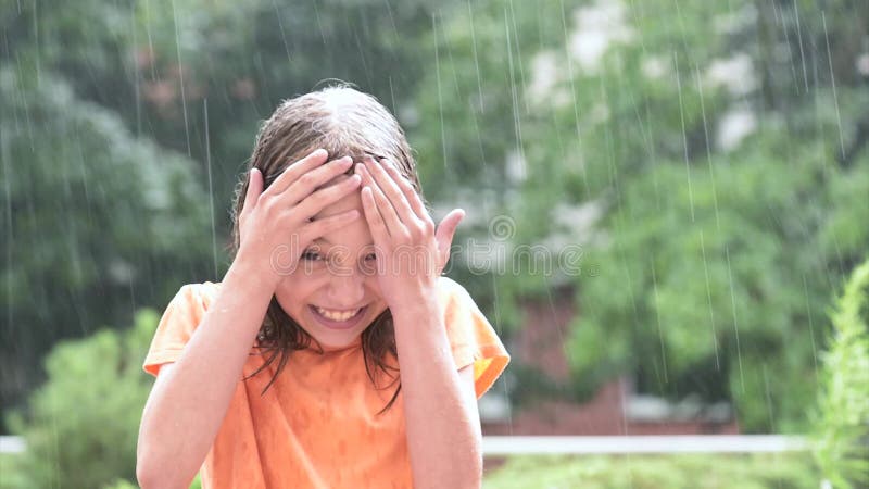 Girl playing in rain stock footage. Video of people, beauty - 73708476