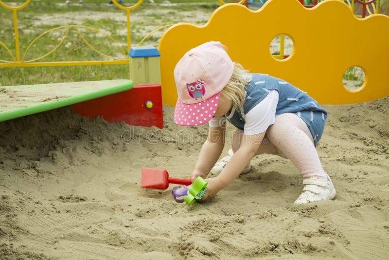 Girl Playing in the Sandbox Stock Photo - Image of plays, dress: 94495296