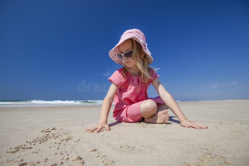 Girl PLaying in Sand at the Beach Stock Photo - Image of ocean, water ...