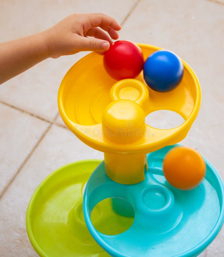 Girl Playing with Some Colored Balls in a Plastic Tower Stock Photo ...