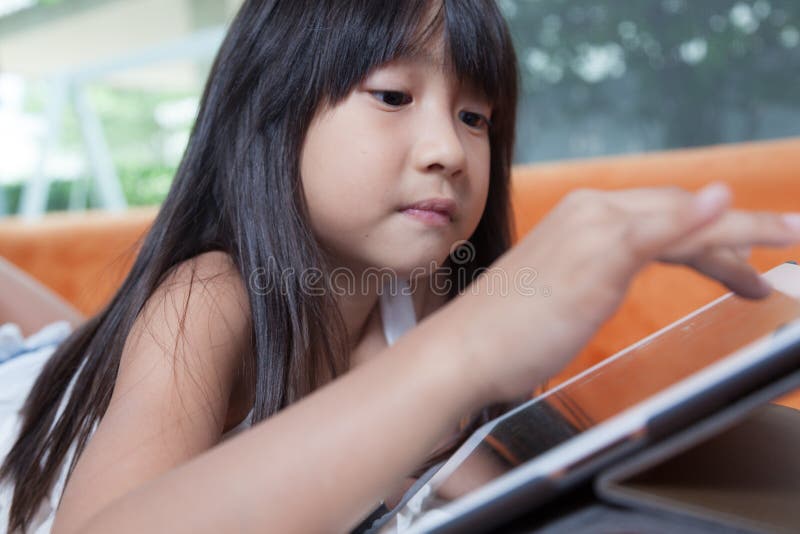 Girl playing with tablet. stock photo. Image of home - 40532088