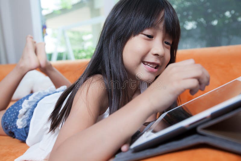 Girl playing with tablet. stock image. Image of human - 40532703