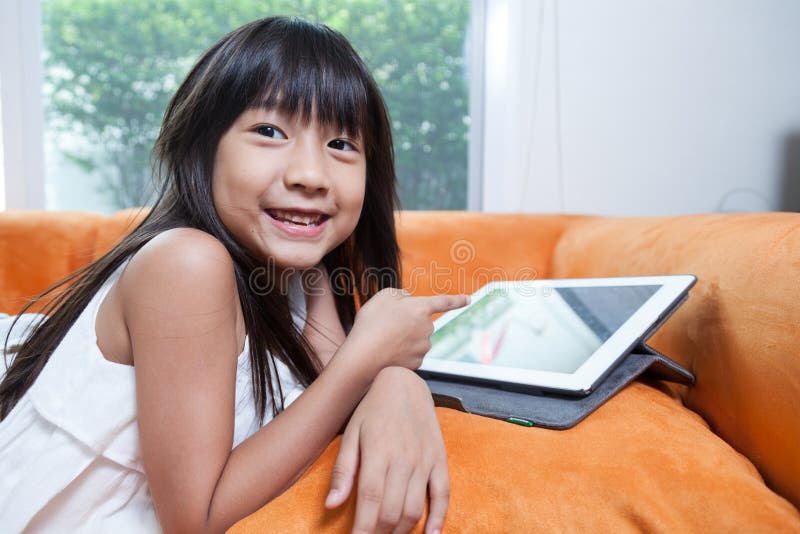 Girl playing with tablet. stock photo. Image of cute - 40533572