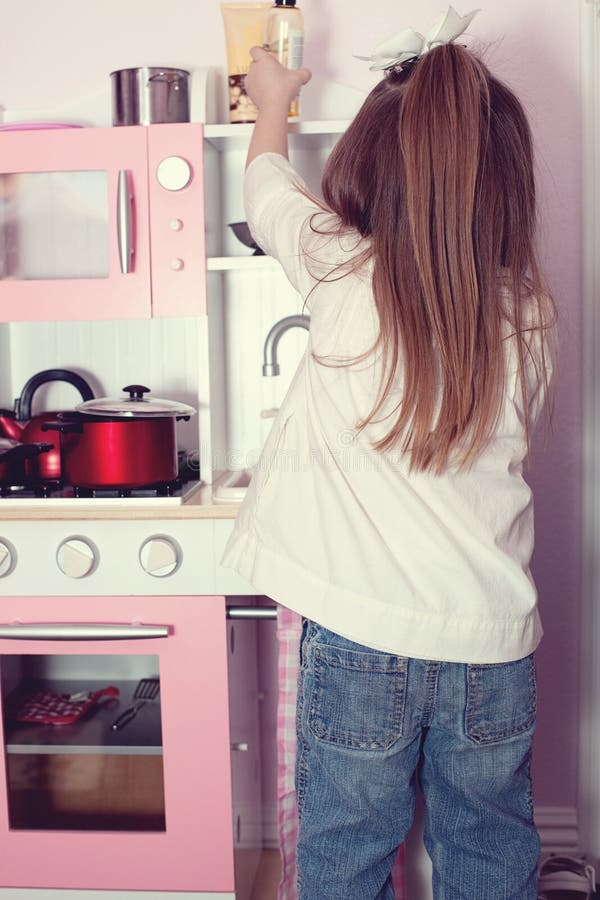 Girl Playing with a Toy Kitchen Stock Image - Image of pretend, curious ...