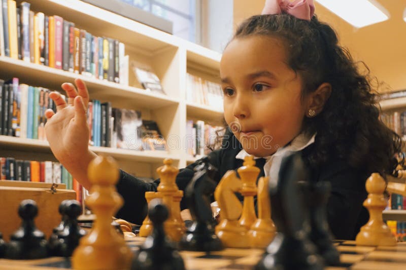 A Girl Plays Chess in a Library Stock Image - Image of bookcase, chess ...