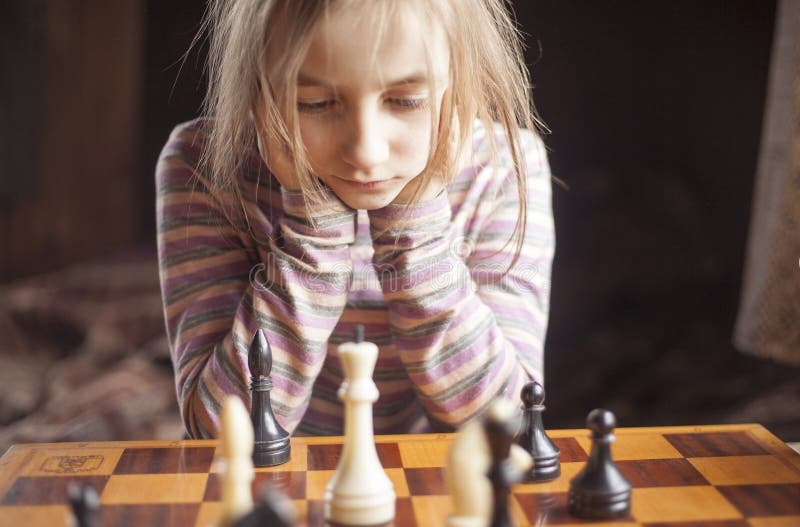 Girl plays chess stock photo. Image of leisure, cute - 70431334