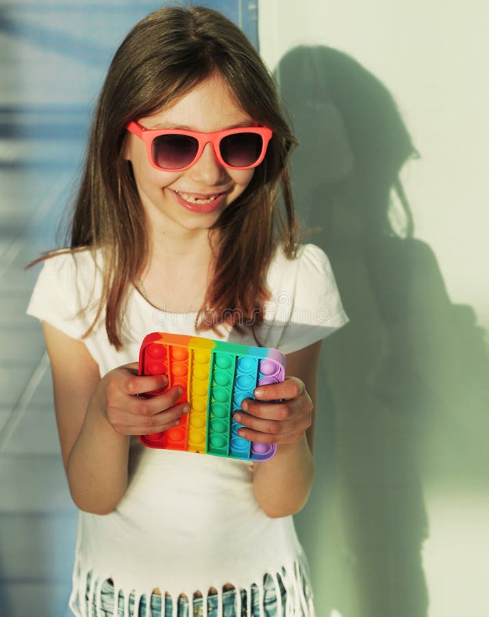 Girl Plays with Simple Dimple Toy. Stock Photo - Image of dimple, hobby ...