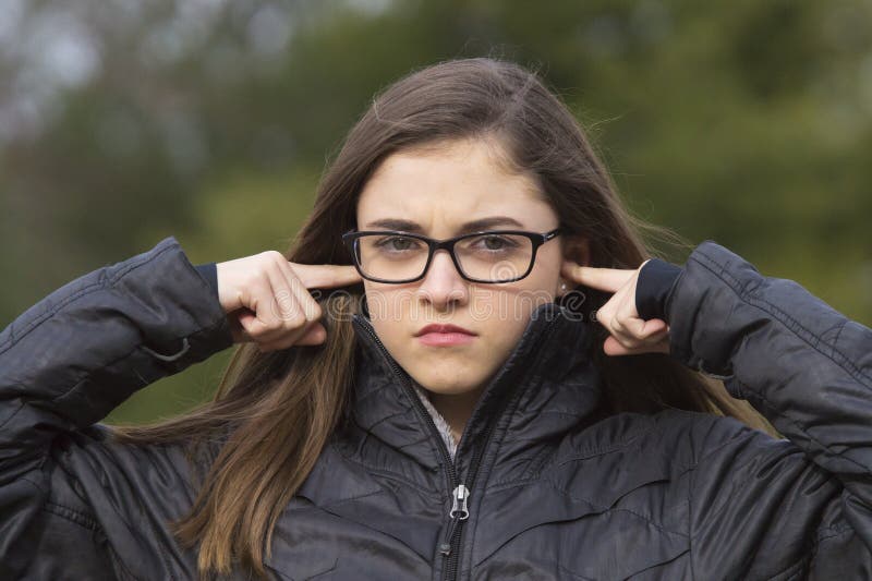 Girl plugging her ears stock image. Image of model, decibel - 66370185