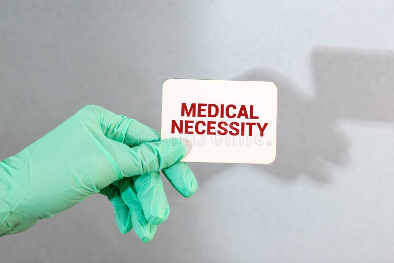 The Girl Points To a Notebook with the Text MEDICAL NECESSITY. Stock ...