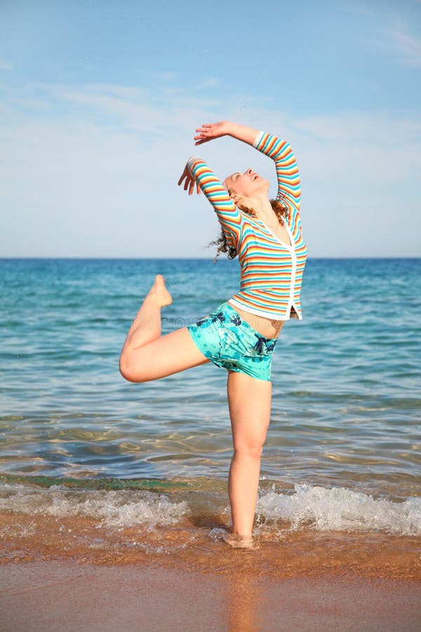 Girl poses on a beach stock image. Image of stretcing - 2520397