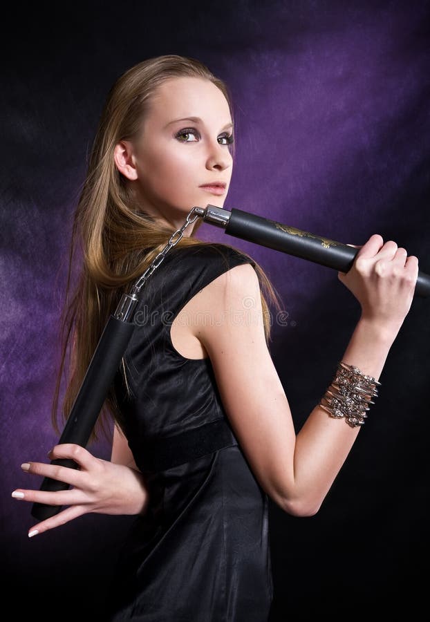 Girl posing with nunchaku stock image. Image of beauty - 7796867