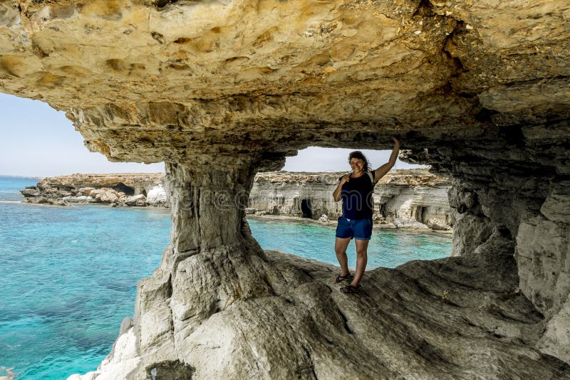 Girl Posing in a Rocky Arch at Cape Greco. Stock Photo - Image of ...
