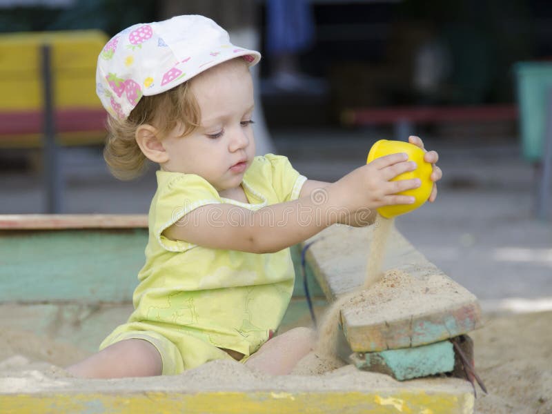 Girl is Pouring Sand in a Sandbox Stock Image - Image of interesting ...